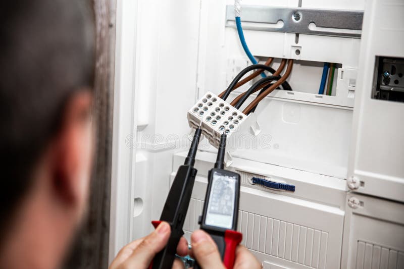 An Electrician Installs a New Switch Box or Fuse Box Stock Image ...