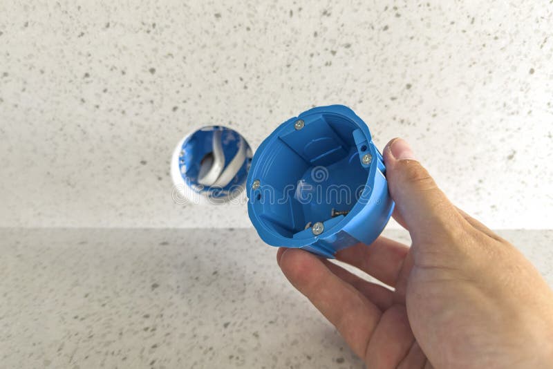 An Electrician Installs a Socket in the Kitchen. Hands of a Qualified ...