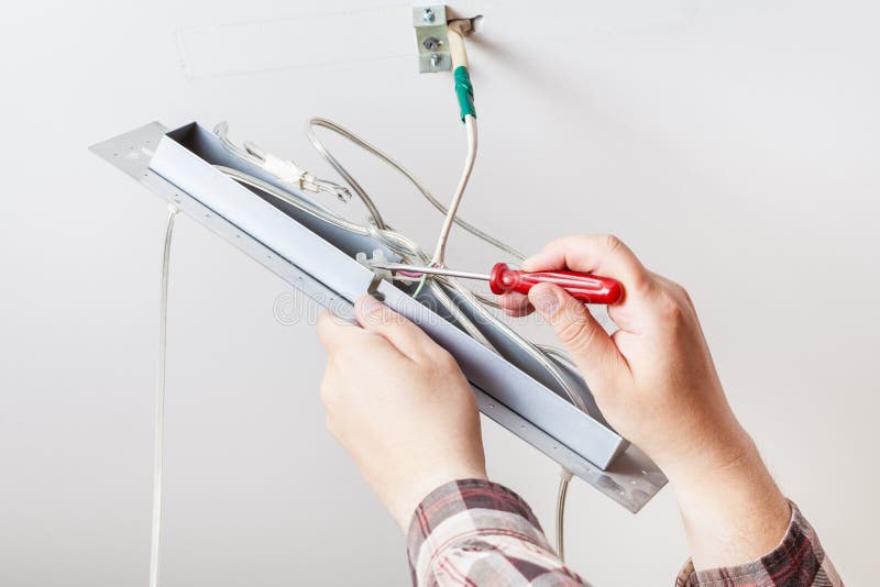 Electrician Installs Wiring in Ceiling Lamp Stock Photo - Image of lamp ...