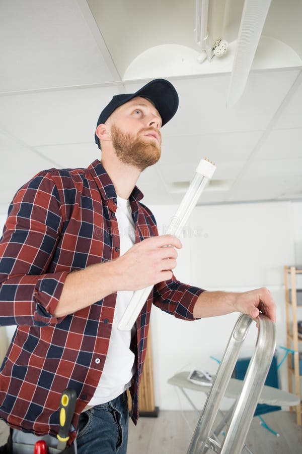 Electrician Man Worker Installing Ceiling Fluorescent in Office Stock ...