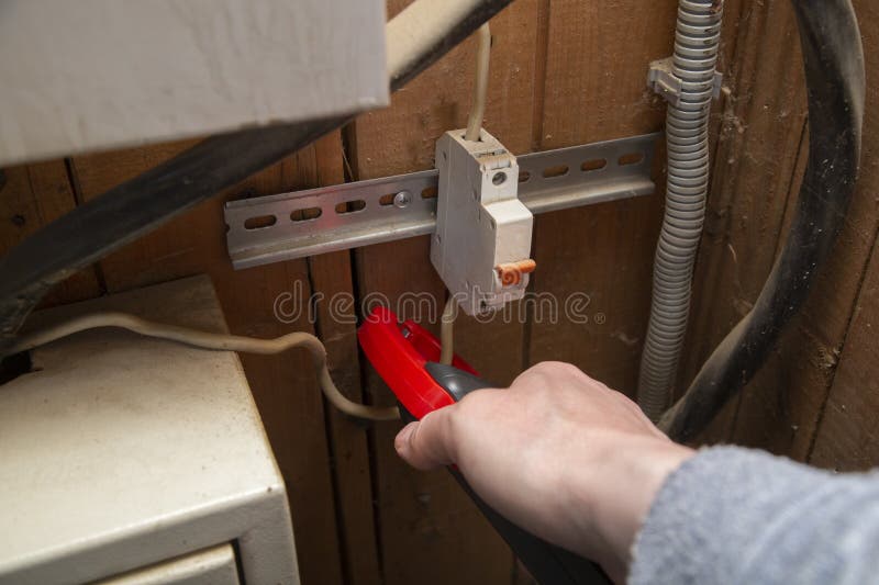 An Electrician Measures the Current Strength Using a Special Device ...