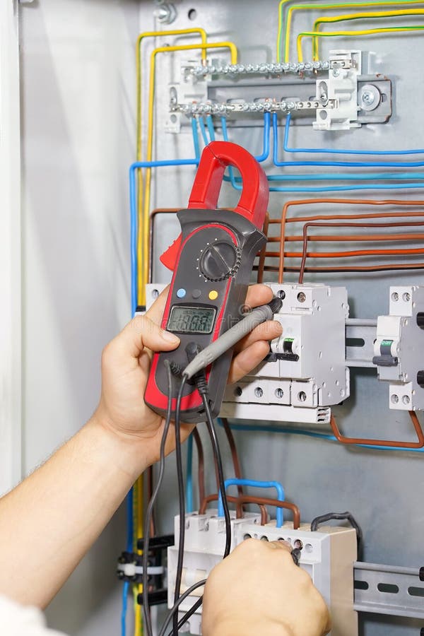 Multimeter is in Hands of Electrician on Background of Electrical ...
