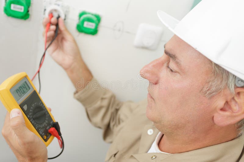 Electrician Measuring Voltage in Socket Stock Photo - Image of repair ...