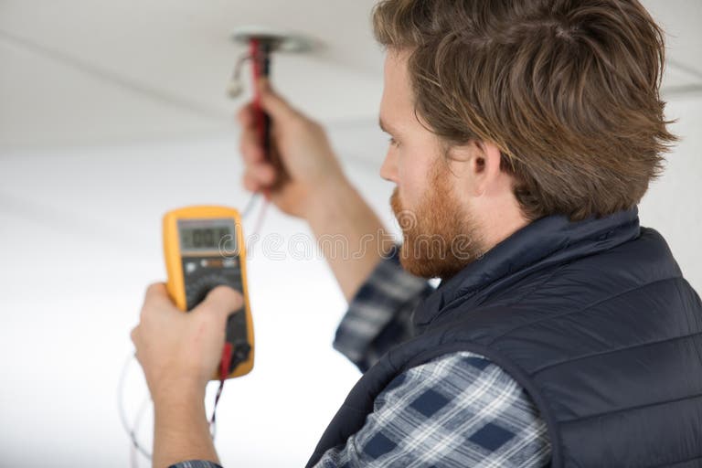 Electrician Measuring Voltage from Wire on Ceiling Stock Photo - Image ...