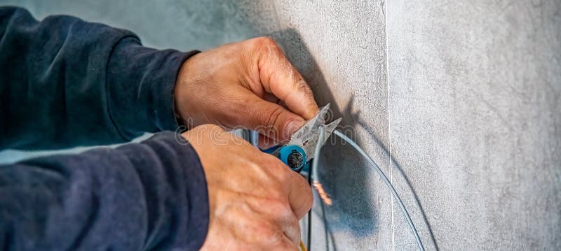 Electrician Mounts an Electrical Outlet To the Wall Stock Image - Image ...