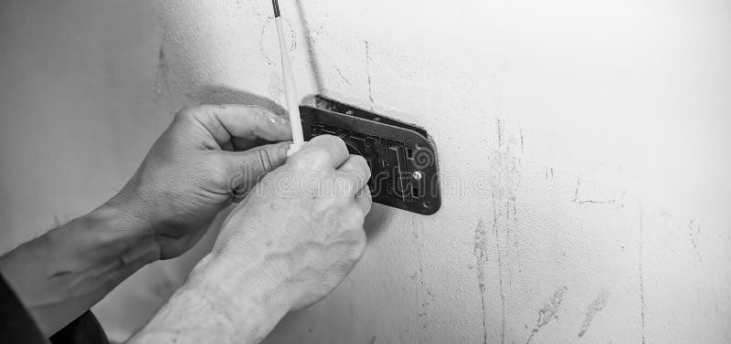 Electrician Mounts an Electrical Outlet To the Wall Stock Image - Image ...