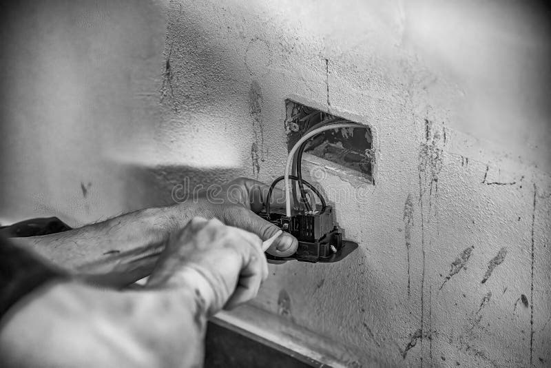 Electrician Mounts an Electrical Outlet To the Wall, Connecting Cables ...