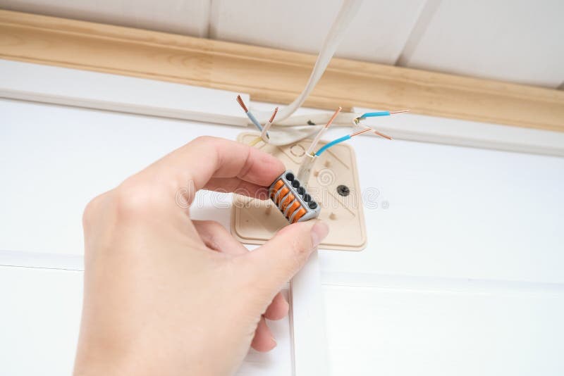 Electrician Mounts Wires on the Wall with a Clamp, Bare Wires on ...