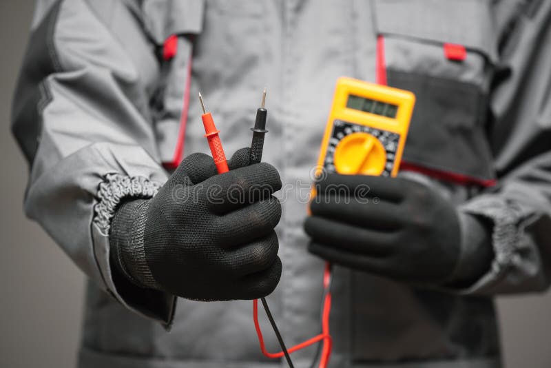 Electrician with a Multimeter Stock Photo - Image of voltage, black ...
