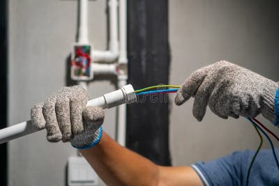 Electrician Pulling Wire into PVC Conduit Stock Image - Image of ...