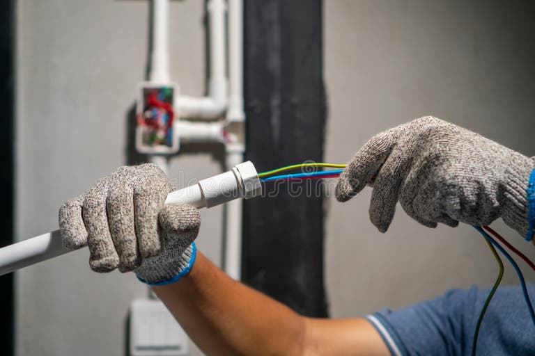Electrician Pulling Wire into PVC Conduit Stock Image - Image of ...