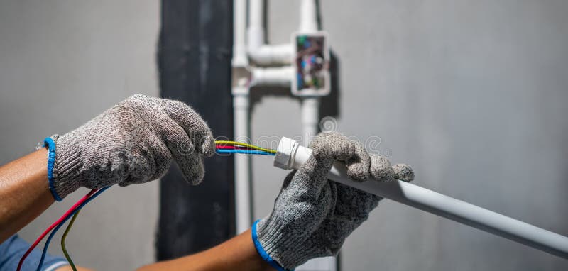 Electrician Pulling Wire through PVC Conduit from Solar Inverter System ...