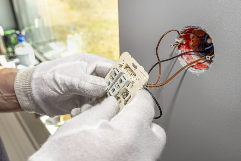 The Electrician Puts the Roller Shutter Switch Up and Down in the ...