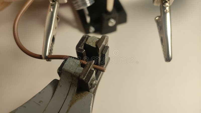 An Electrician Removes Insulation from Electrical Wiring with a Special ...