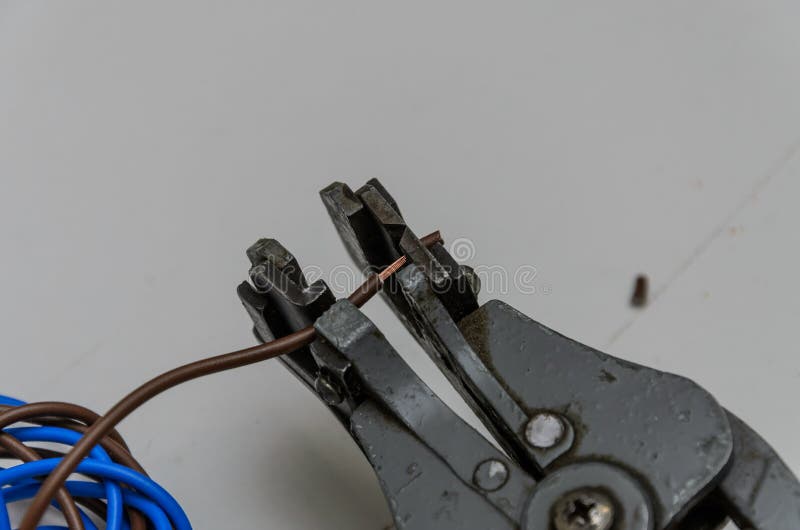 An Electrician Removes Insulation from Electrical Wiring with a Special ...