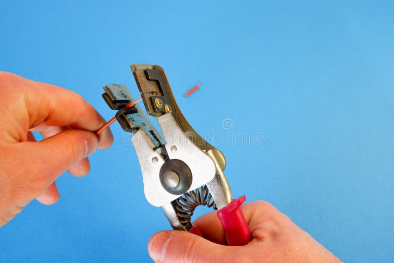 The Electrician Removes the Insulation from the Wire Using a Special ...