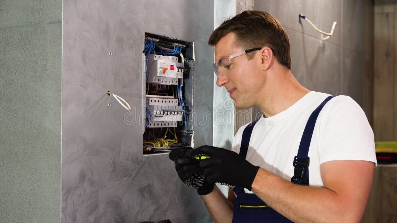 Electrician Repairing Electrical Box and Using Screwdriver in Corridor ...