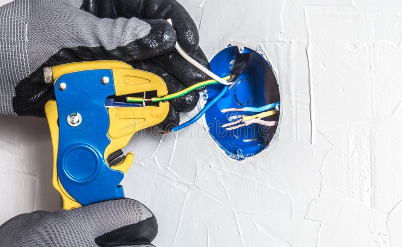 The Electrician`s Hands with a Special Tool Clean the Wires in a ...