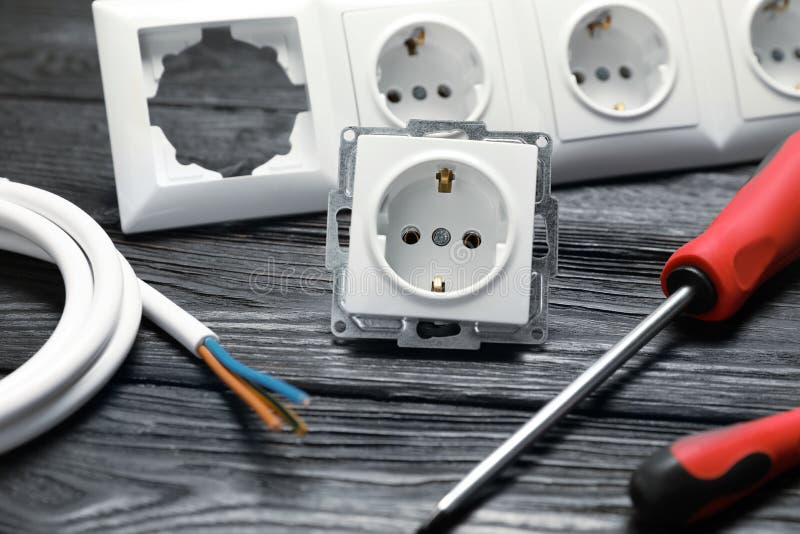 Electrician`s Tools and Power Sockets on Black Wooden Table Stock Photo ...