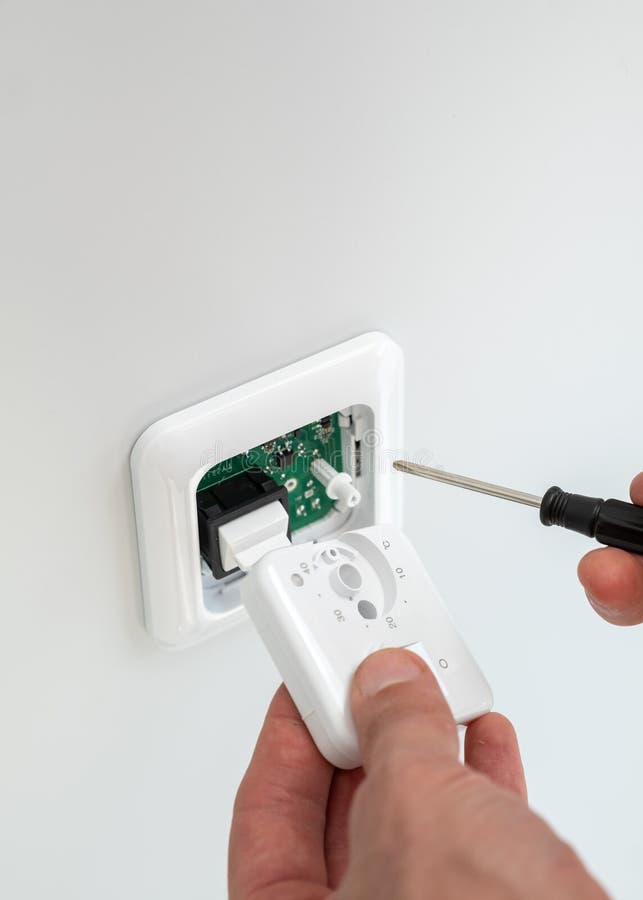 Electrician with Screwdriver Repairing Power Socket in Room. Stock ...