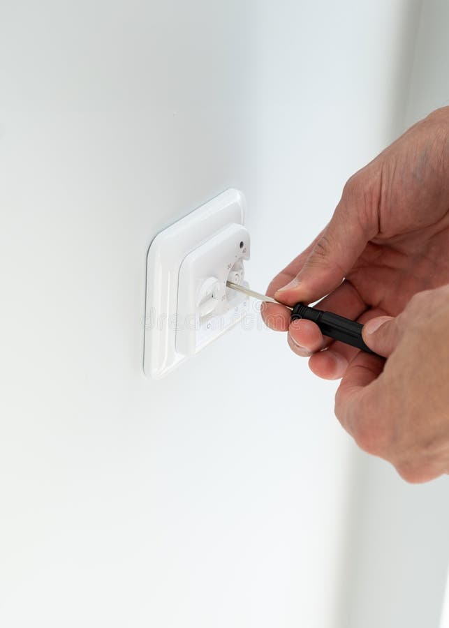 Electrician with Screwdriver Repairing Power Socket in Room. Stock ...