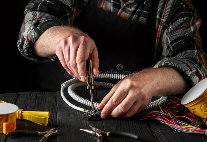 Electrician Screws the Wire To the Connector with a Screwdriver. Close ...