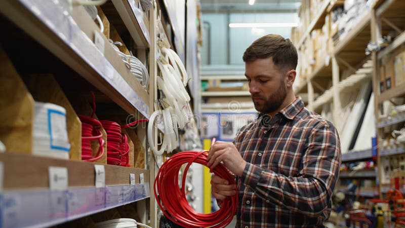 A Man Sells Electrical or Ethernet Cables in a Hardware Store Stock ...