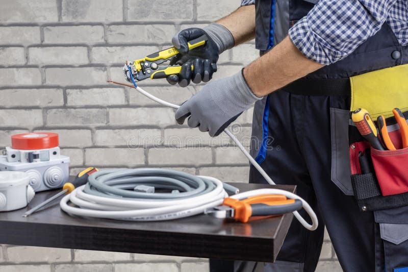 Electrician Stripping Insulation from Wire. Man Electrician Working ...