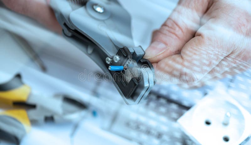 Electrician Stripping a Wire; Light Effect Stock Photo - Image of ...
