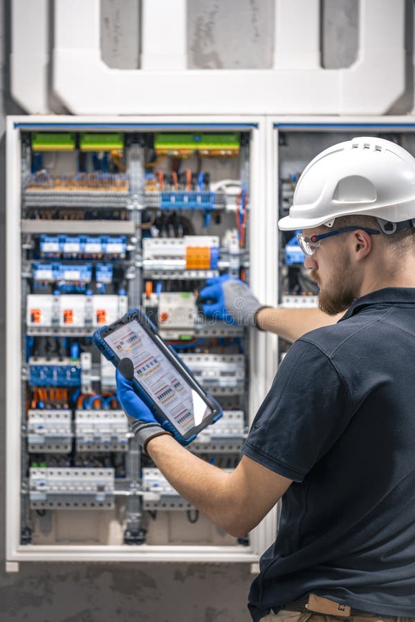 Electrician with Tablet Adjusting Circuitry at Junction Box. Stock ...