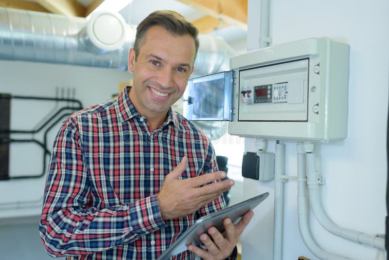 Electrician with Tablet Next To Circuit Breaker Box Stock Photo - Image ...