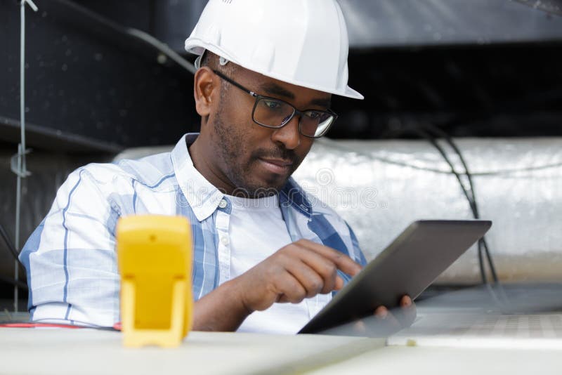 Electrician with Tablet PC Near Distribution Board Indoors Stock Photo ...