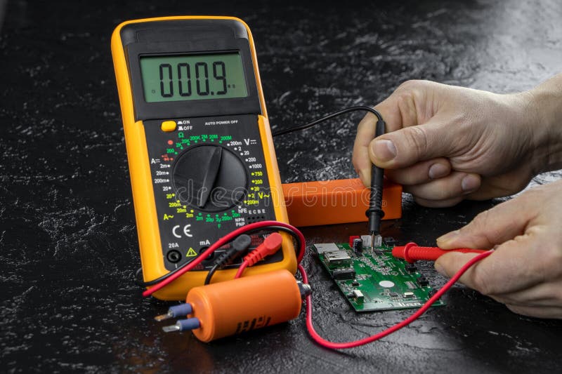 An Electrician Takes Readings from a Microcircuit Using a Multimeter ...