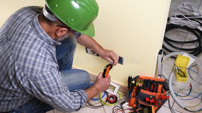 Electrician Technician at Work on a Residential Electric System ...