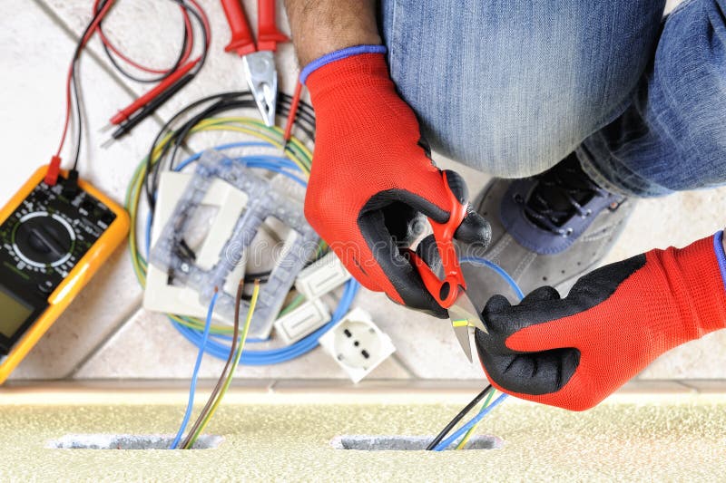 Electrician Technician at Work with Safety Equipment on a Residential ...