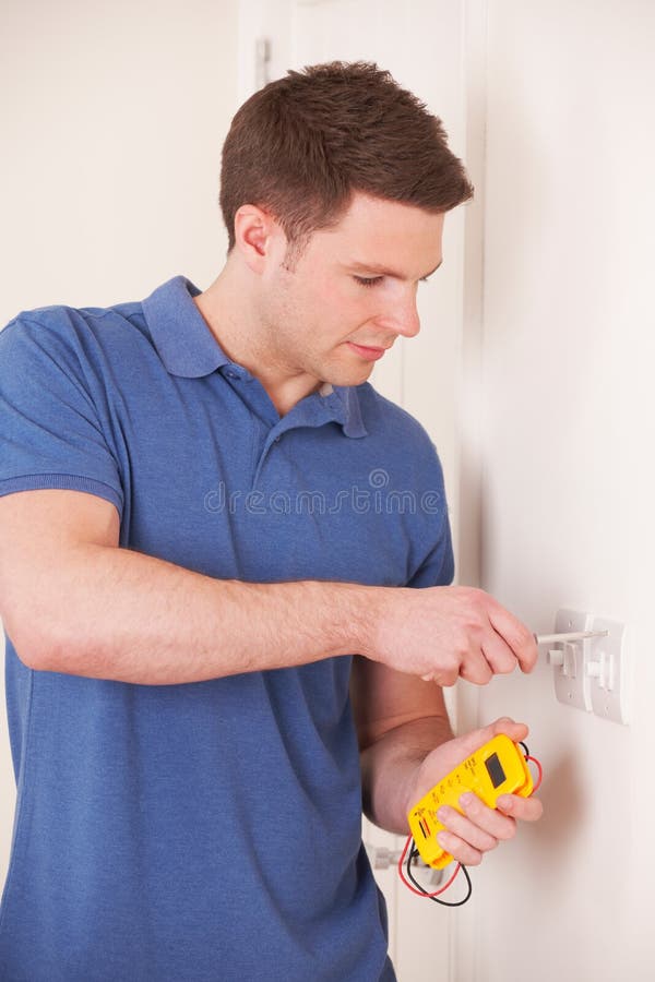 Electrician Testing Power Supply At Fuseboard Stock Photo - Image of ...