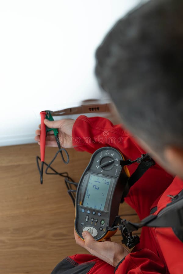 Electrician Tests Socket Voltage with a Specialized Device, Ensuring ...