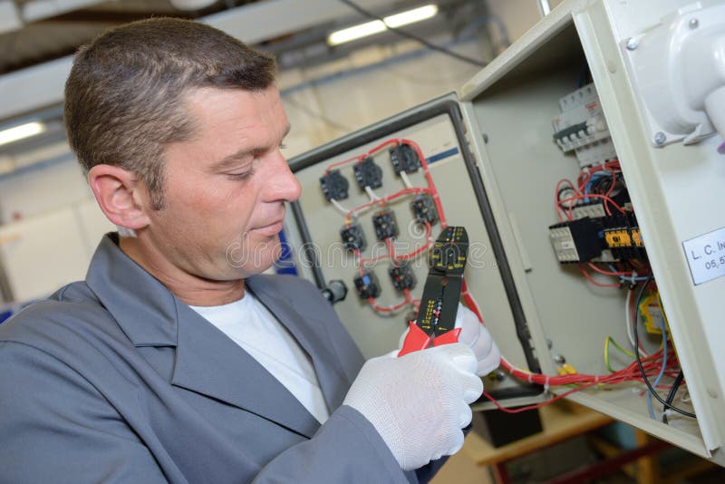 Electrician Using Cable Strippers Stock Photo - Image of insulating ...