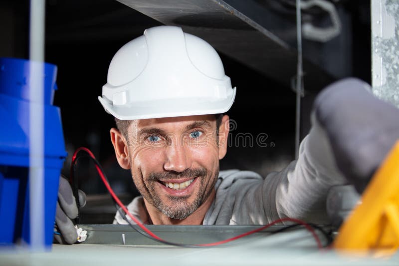 Electrician Using Multimeter in Roof Space Stock Image - Image of ...