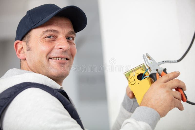 Electrician Using Multimeter and Smiling Stock Image - Image of ...