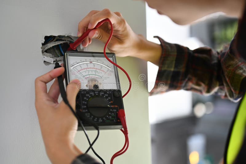 Electrician Using a Multimeter To Test the Electrical Installation and ...