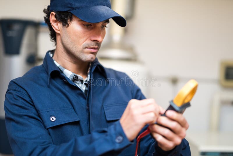 Electrician using a tester stock photo. Image of industry - 69491696