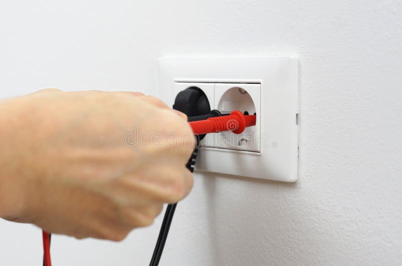 Hand of an Electrician with Multimeter Probe at an Electrical Sw Stock ...