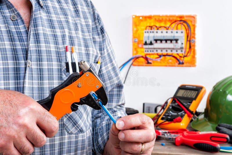 Electrician at Work on Cables with Wire Stripper. Stock Photo - Image ...