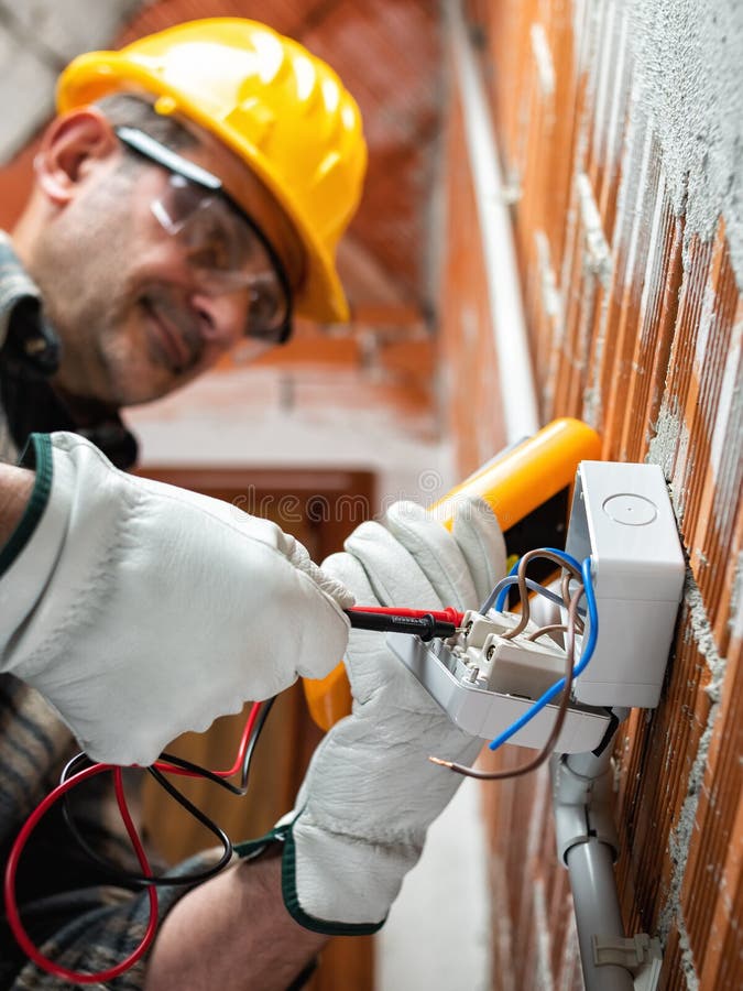 Electrician at Work in an Electrical System of a Construction Site ...