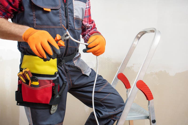 Electrician at Work with Nippers in Hand Cut the Electric Cable ...