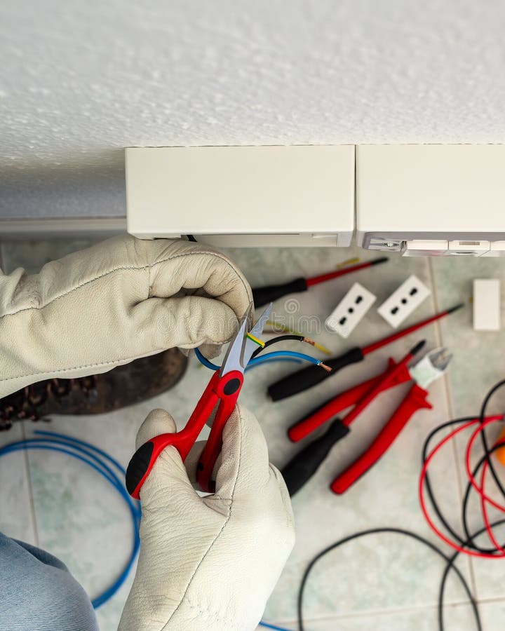 Electrician at Work on a Residential Electrical System. Electricity ...