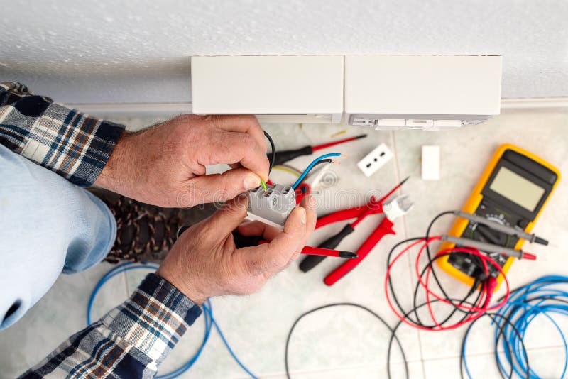 Electrician at Work on a Residential Electrical System. Electricity ...