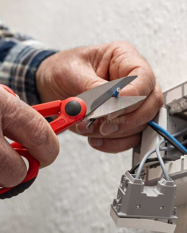 Electrician at Work on a Residential Electrical System. Electricity ...