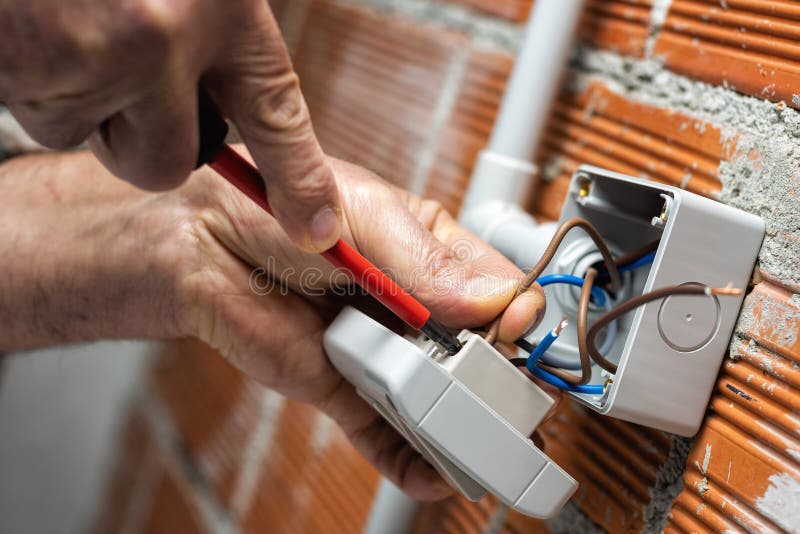 Electrician at Work on a Residential Electrical System. Electricity ...